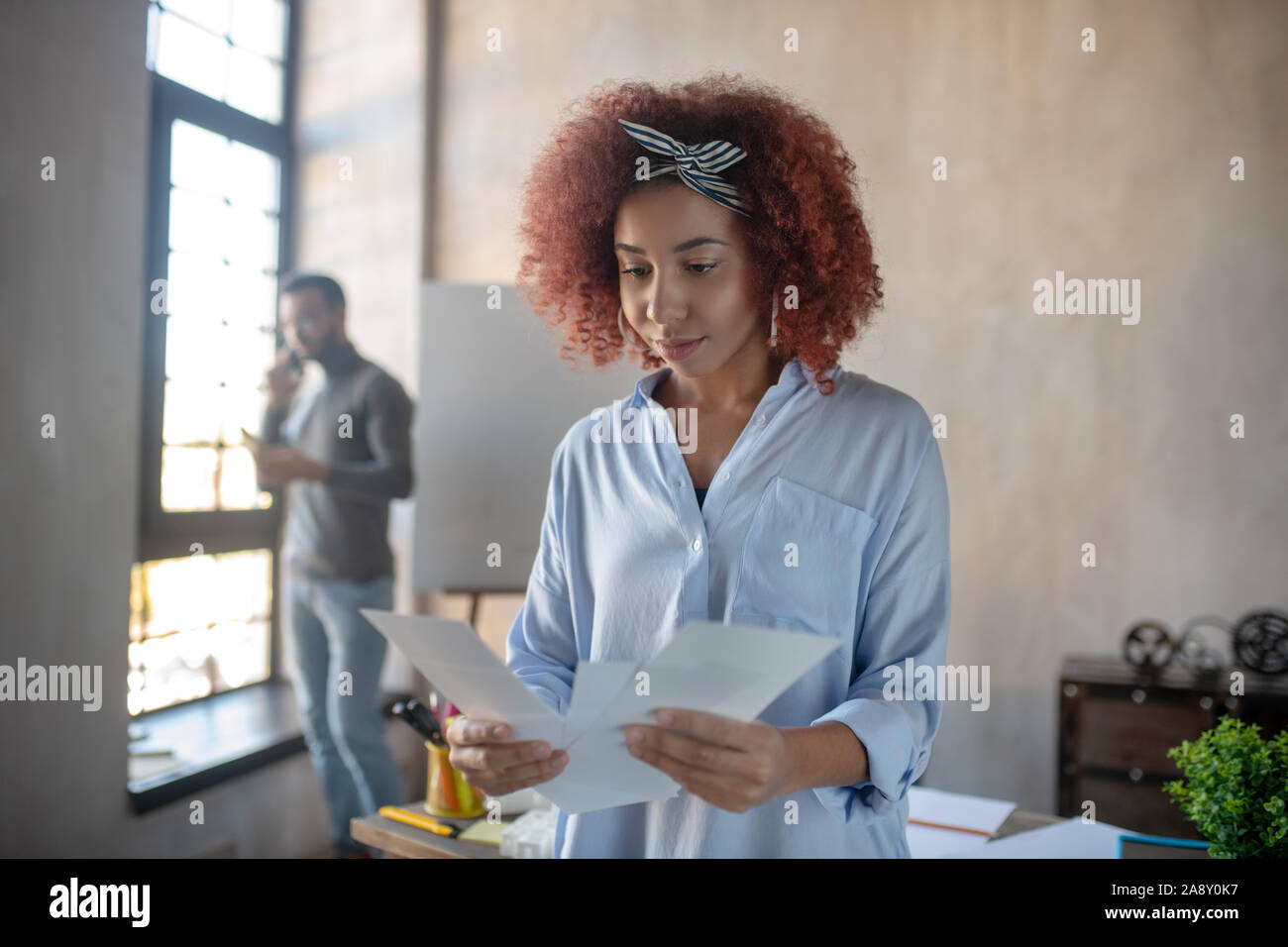 Designer looking at color palettes while planning project Stock Photo ...