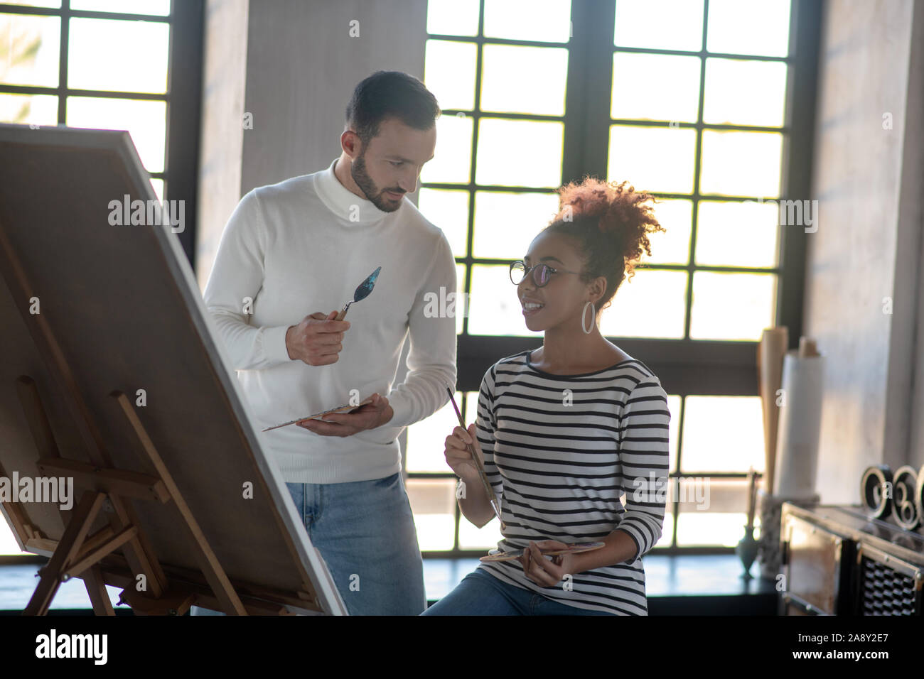 Professional artist giving master class for his friend Stock Photo - Alamy