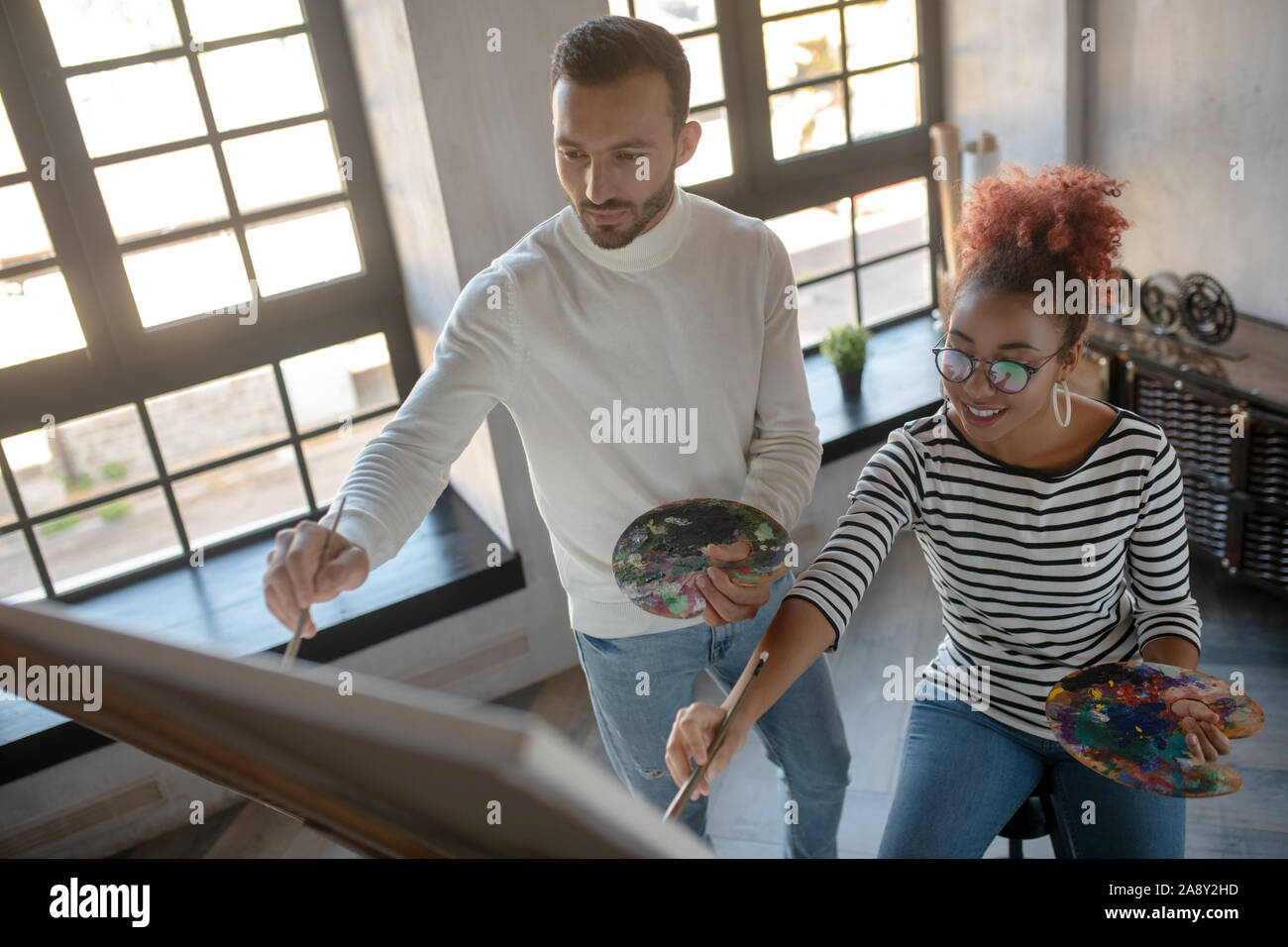 Top view of couple of artists painting together Stock Photo - Alamy