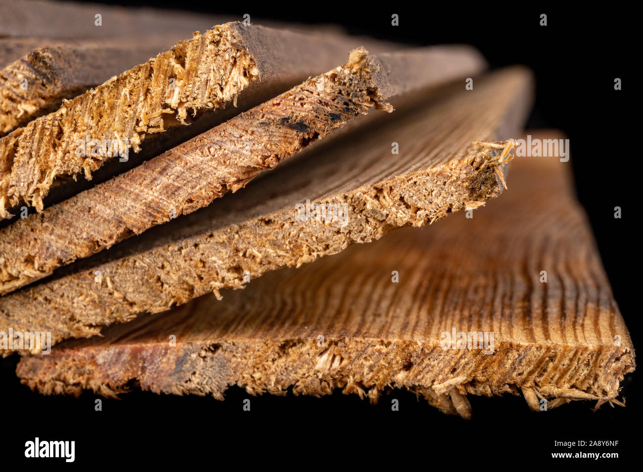Raw wooden boards. Heavily jagged wood edges. Dark background Stock ...