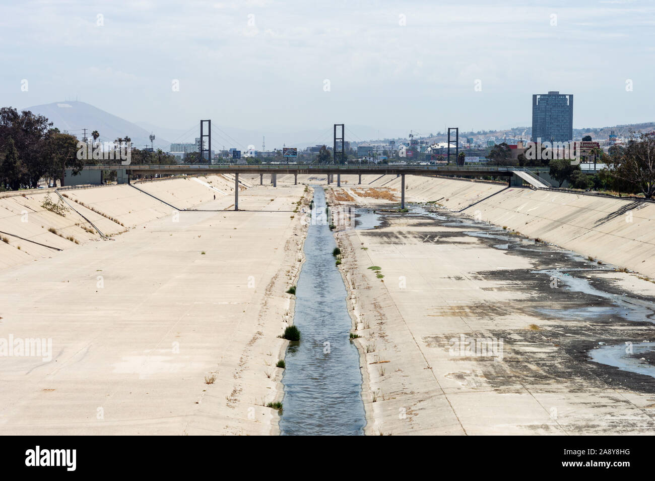 TIJUANA, MEXICO - 07/22: Tijuana river under a bridge with the colored ...