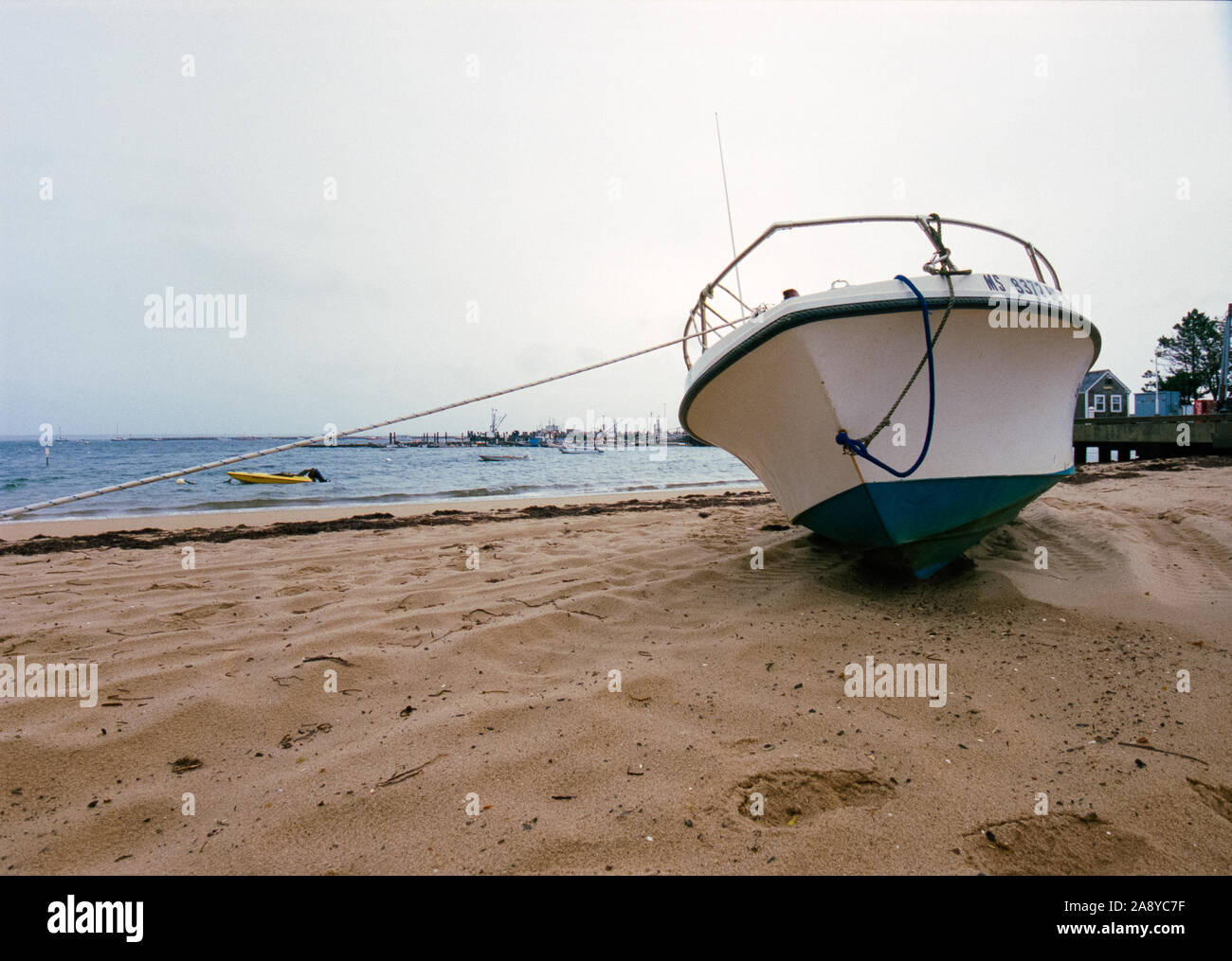A beached boat on a sandy beach by the sea Stock Photo - Alamy