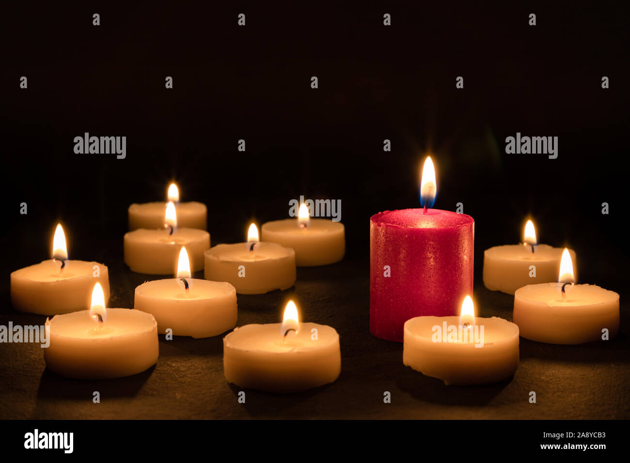 The odd one - Playing with different candles Stock Photo - Alamy