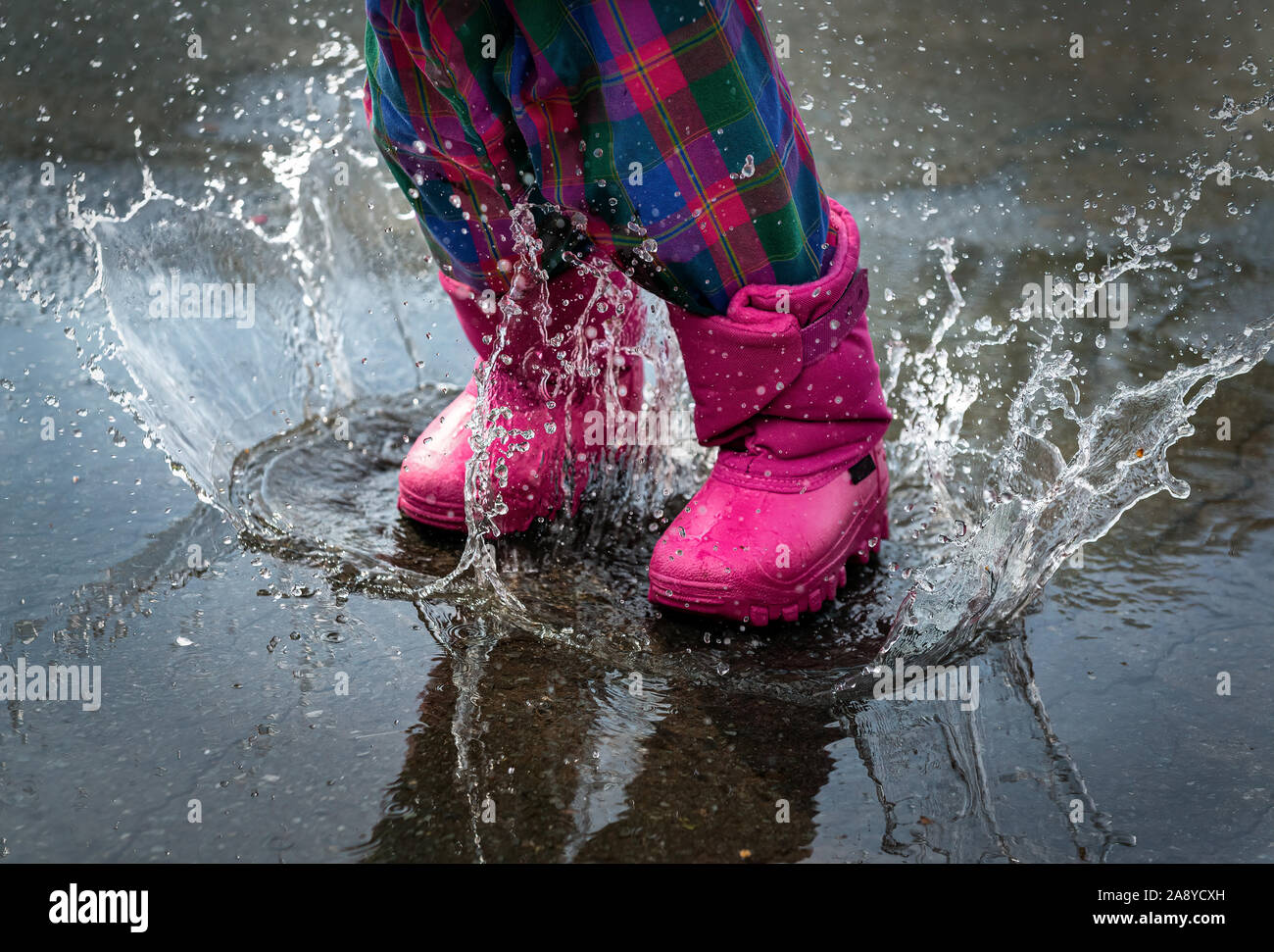 Child splashing in rain hi-res stock photography and images - Alamy
