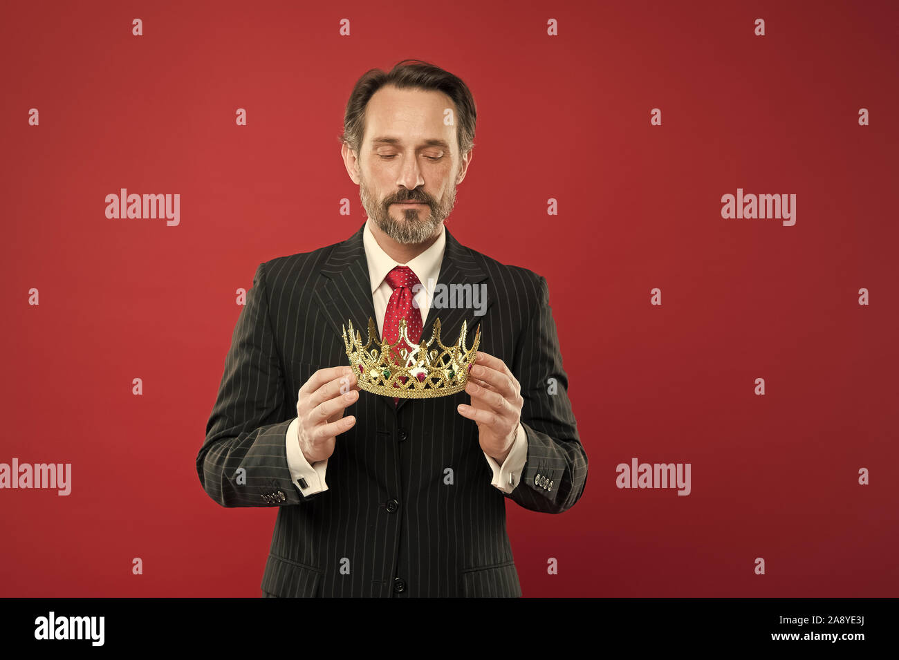 Monarchy family traditions. Man bearded guy in suit hold golden crown ...