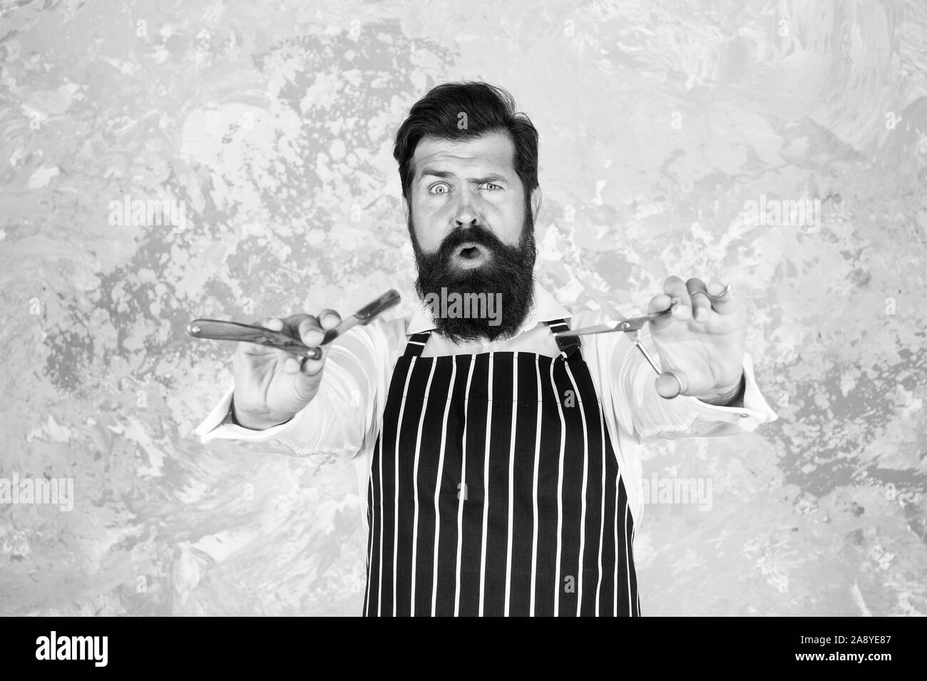 Facial hair. Bearded barber shaving. Barber tools. Barber in apron ...