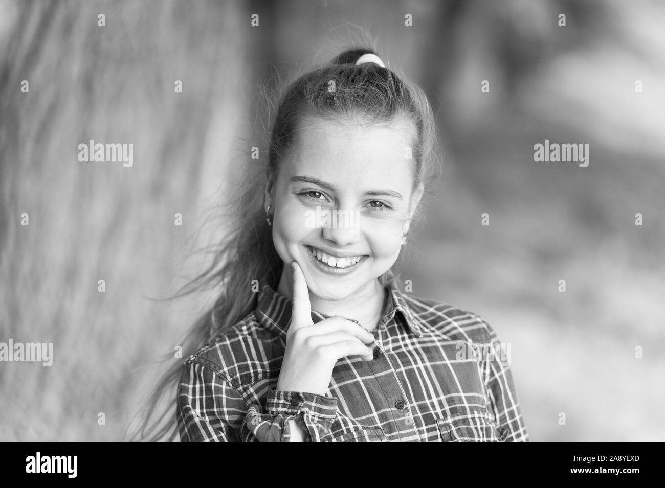 Enjoying the young skin. Happy little girl touching smooth baby skin ...