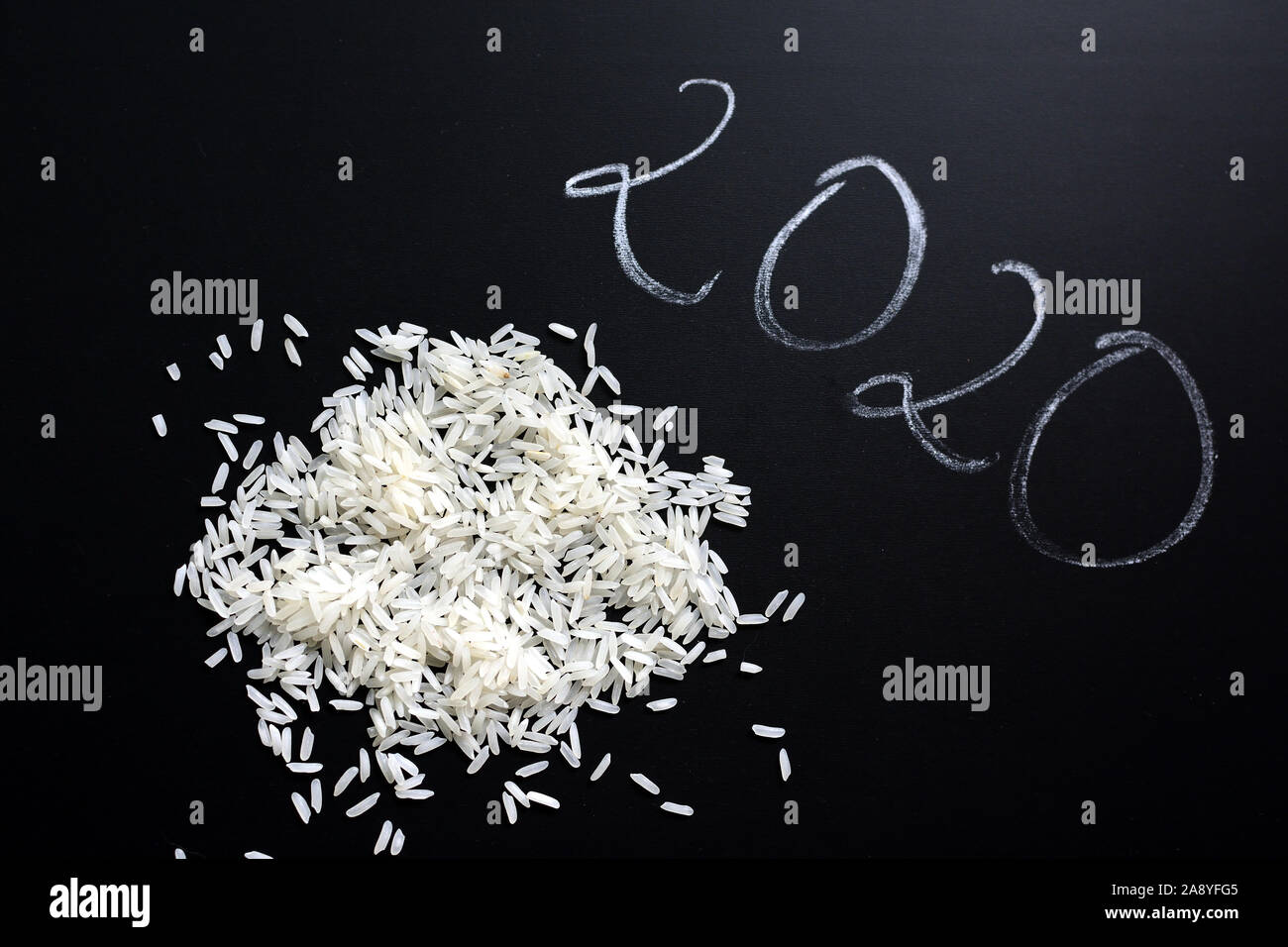 Asian raw rice over black background with number 2020 from above Stock ...