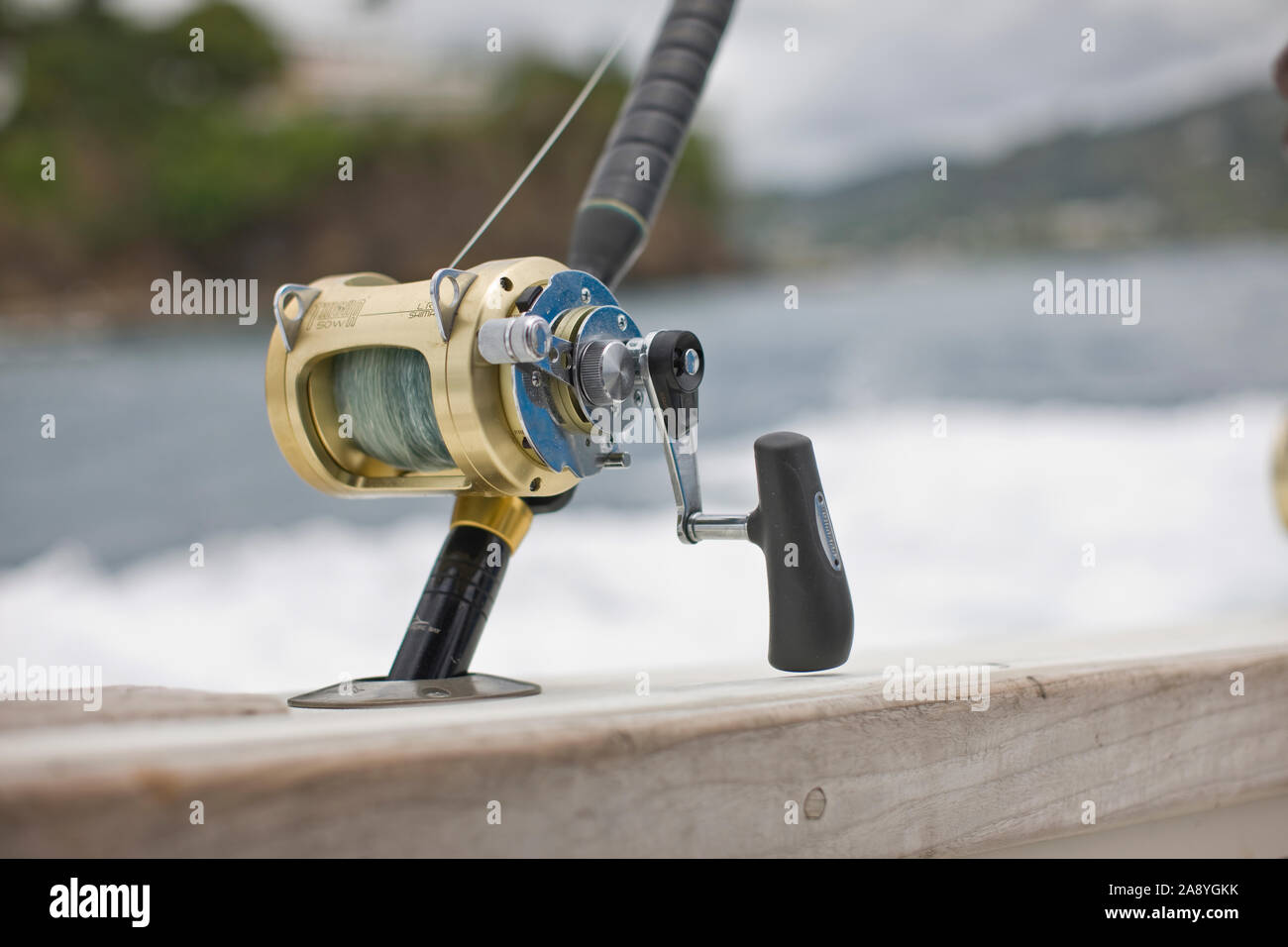 Single fishing rod secured to the edge of a boat Stock Photo - Alamy