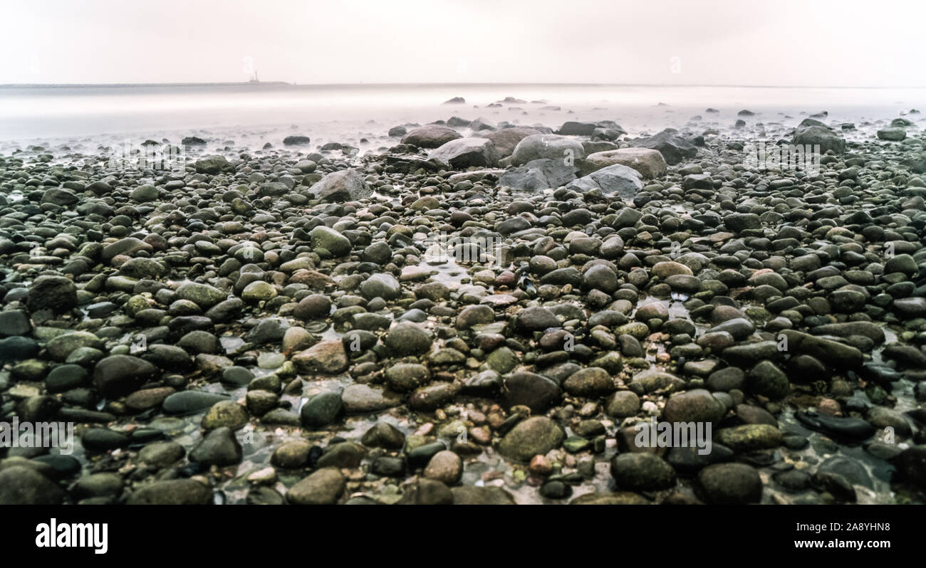 A Grey Rocky Beach in the Mist Stock Photo - Alamy