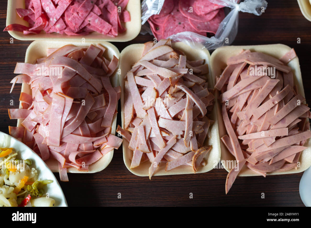different types of hams put on the table Stock Photo - Alamy