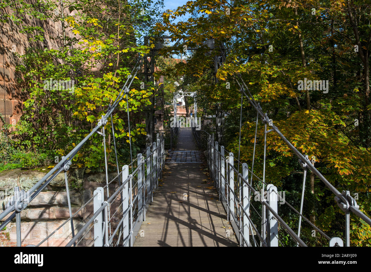 Walking across the historic Chain Bridge in the city of Nuremberg in ...