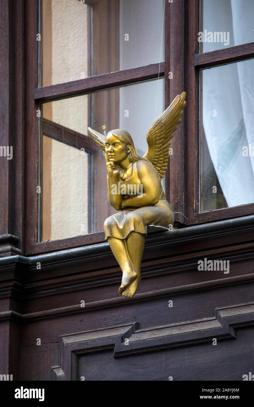 An angel sculpture sitting on a wooden balcony in the historic city of ...