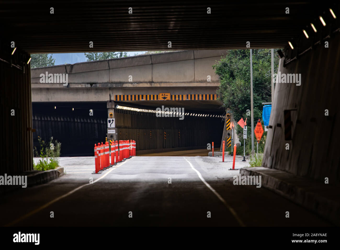 Caution, warning traffic cones at the tunnel exit of the highway ...