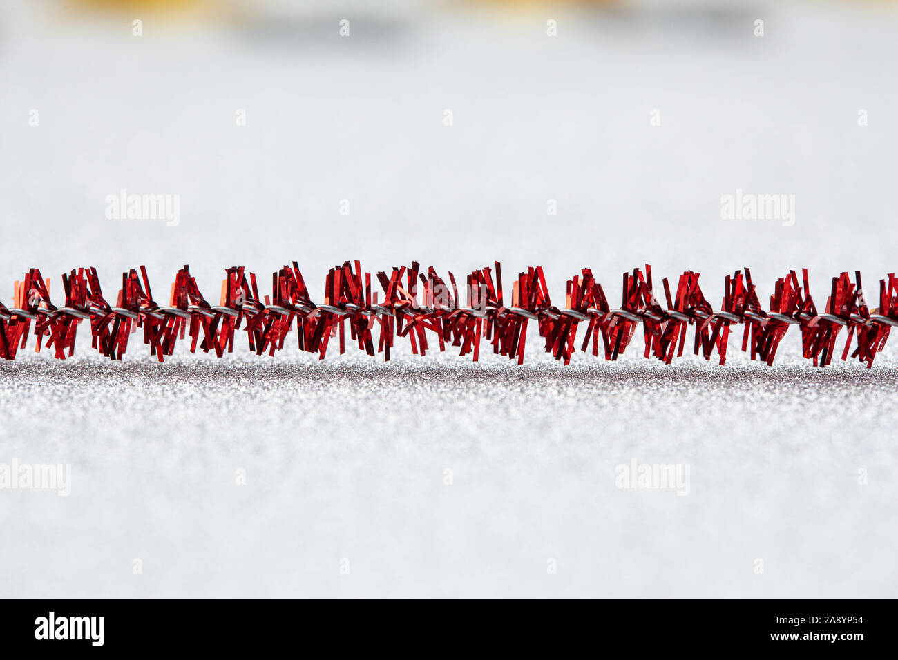 Extreme closeup of Christmas decoration on silver glittery background ...