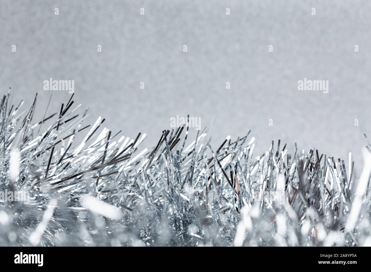 Silver tinsel extreme closeup with shallow focus and copy space ...