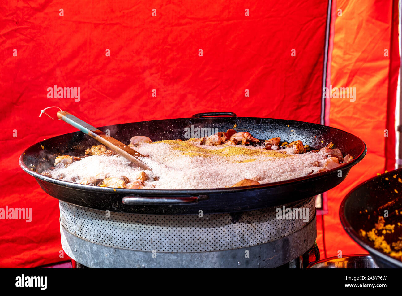 Large frying pan with rice and chicken meat - street food with copy ...