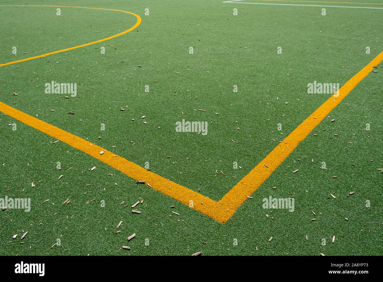Yellow marking on artificial grass soccer and netball field closeup ...