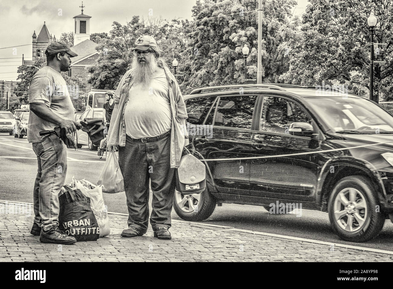 Two men talking in Harvard Square Stock Photo - Alamy