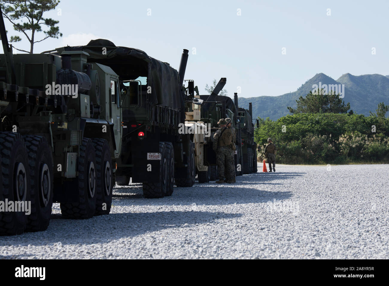 U.S. Marines inspect their vehicles after a convoy during a field ...