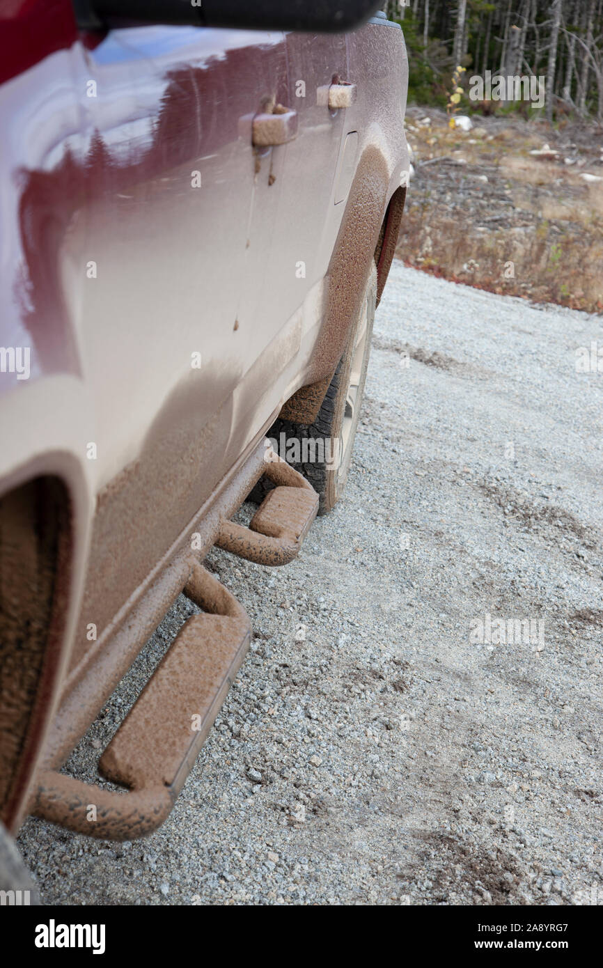 side of a red pickup truck covered with mud from off roading Stock ...