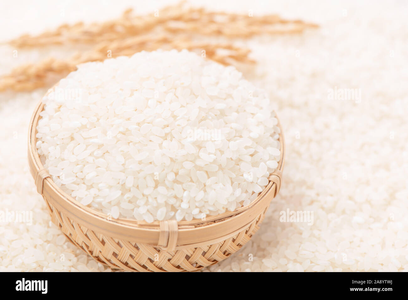 Raw white polished milled edible rice crop on white background in brown ...