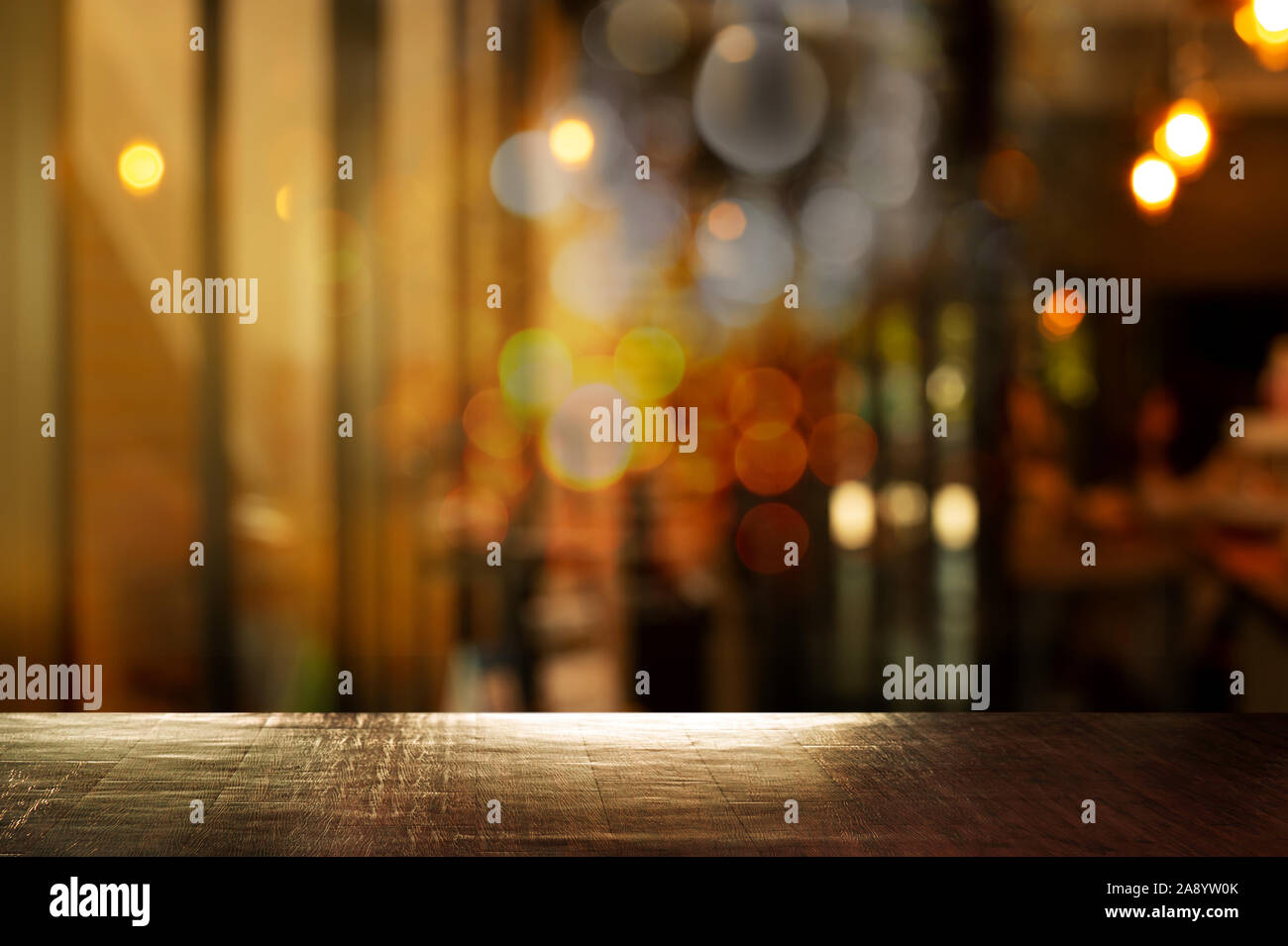 top of brown black wood table with blur party bokeh light in bar or pub ...