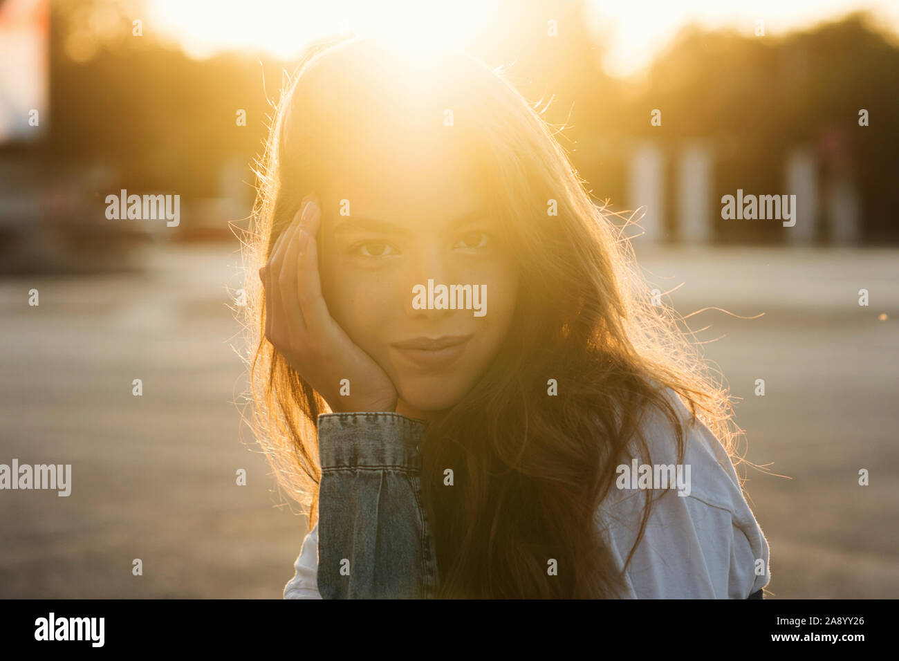 Back light portrait of a happy single teen girl breathing fresh air in ...