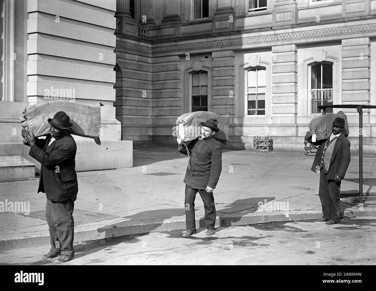 Workers carrying bags of franked mail at the U.S. Capitol ca. 1913 ...
