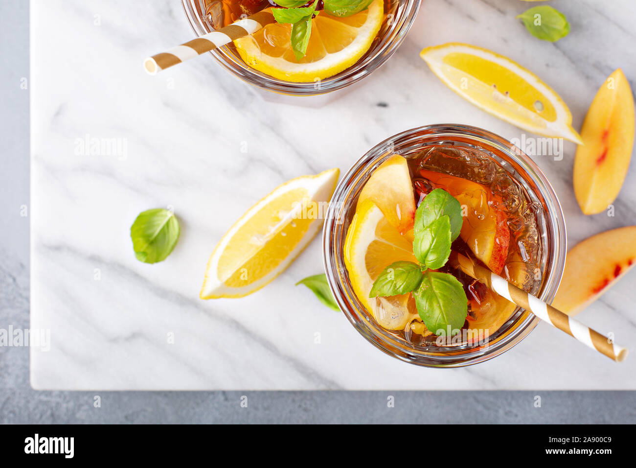Peach and lemon sweet iced tea on a marble surface overhead shot Stock ...