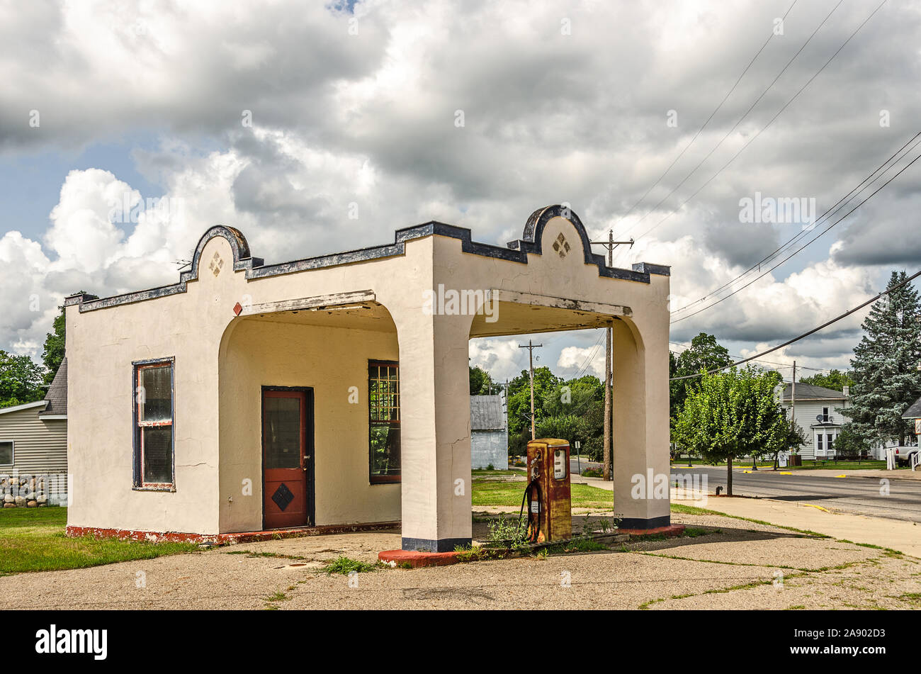 Small gas station with one rusty gas pump and a red door Stock Photo ...