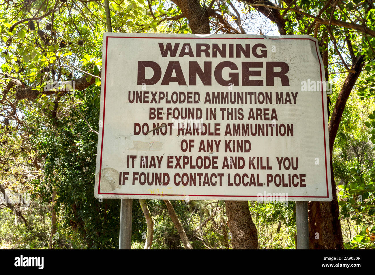 Warning sign announcing the danger of unexploded ammunition in the area ...