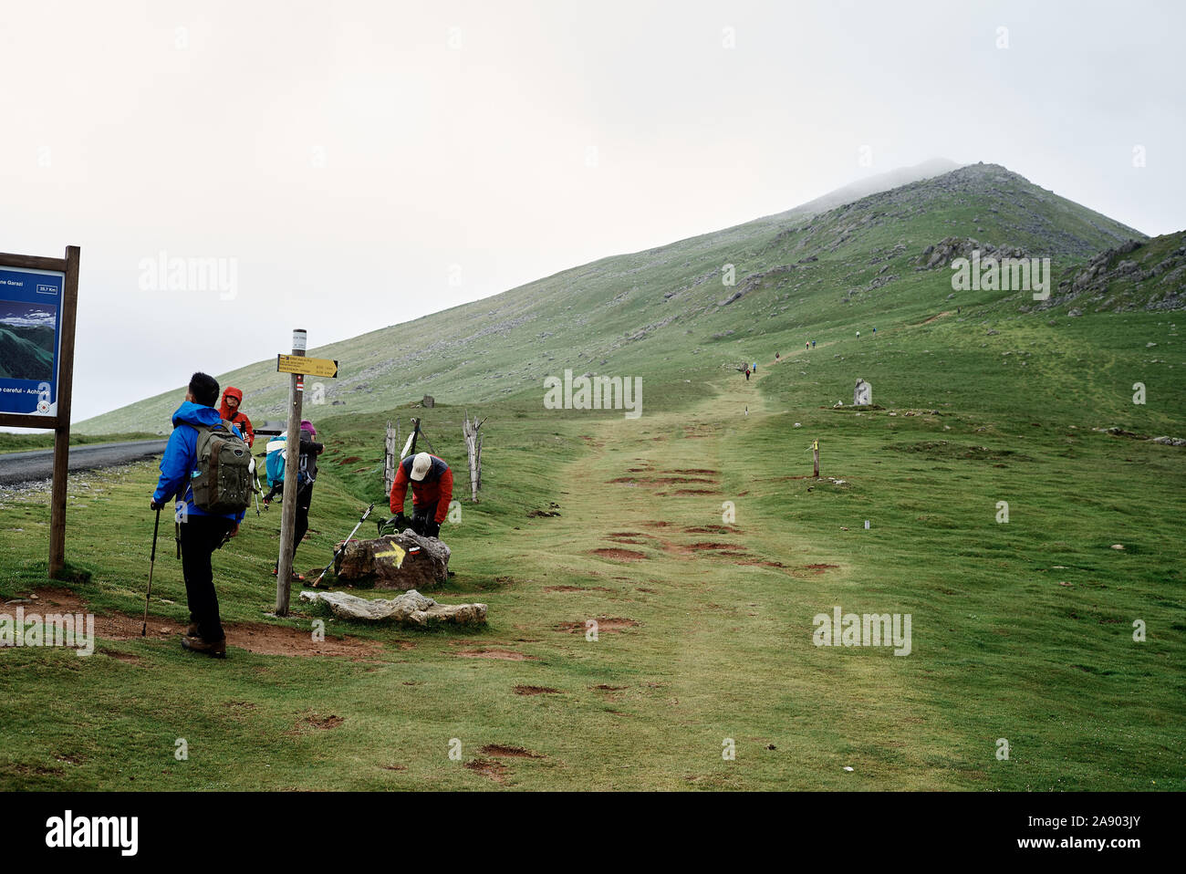 Orisson, France-May 20, 2017: Pilgrims study a signboard before ...