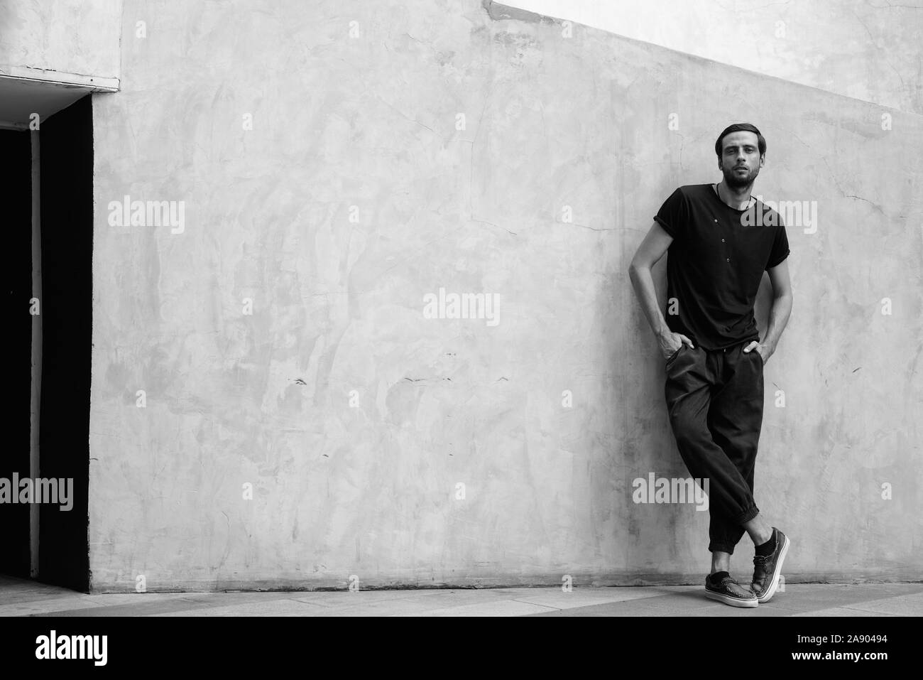 Handsome man against concrete wall in the streets outdoors Stock Photo ...