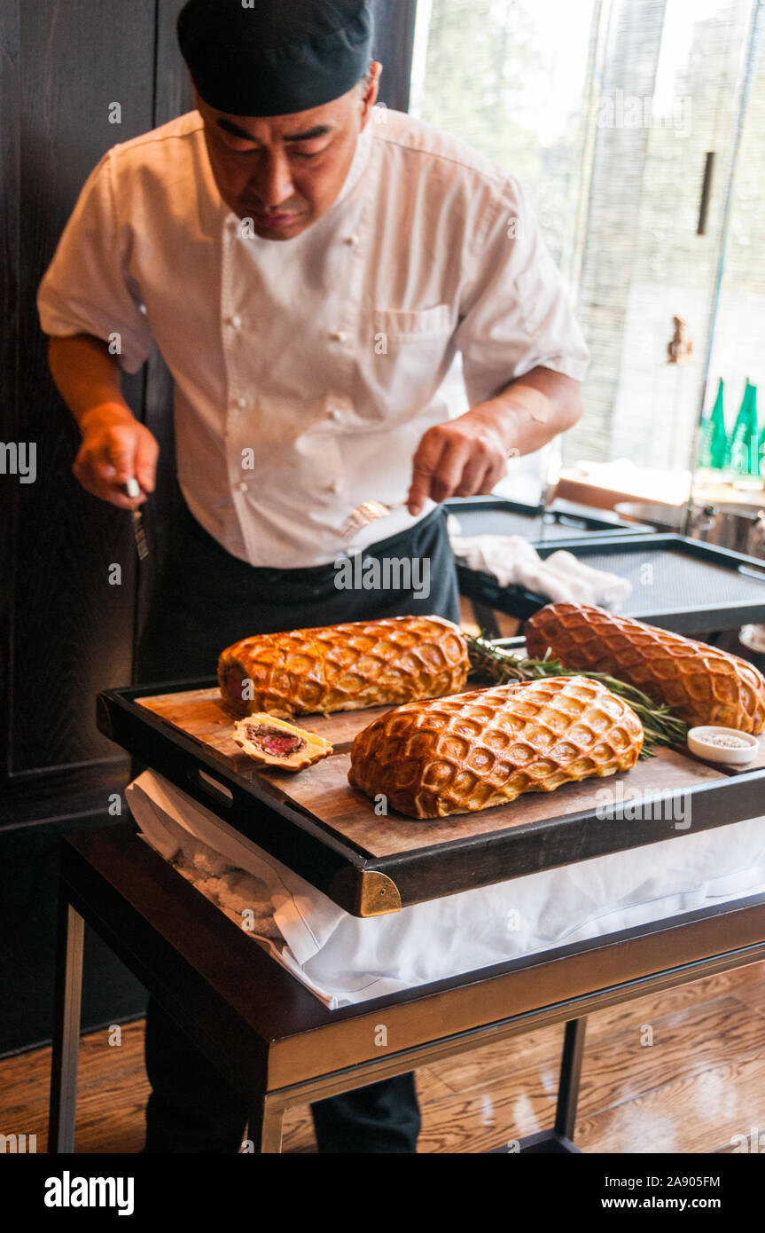 A chef carving a Beef Wellington Rossini as served at a lunch in Puli’s ...