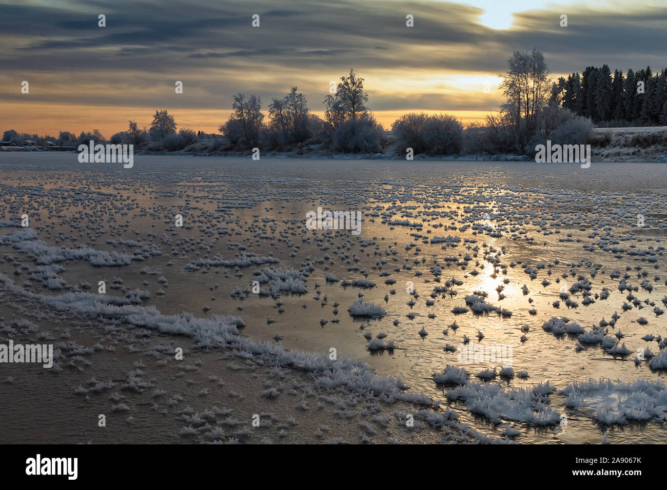 The river is slowly freezing at the Northern Finland. The cold weather ...
