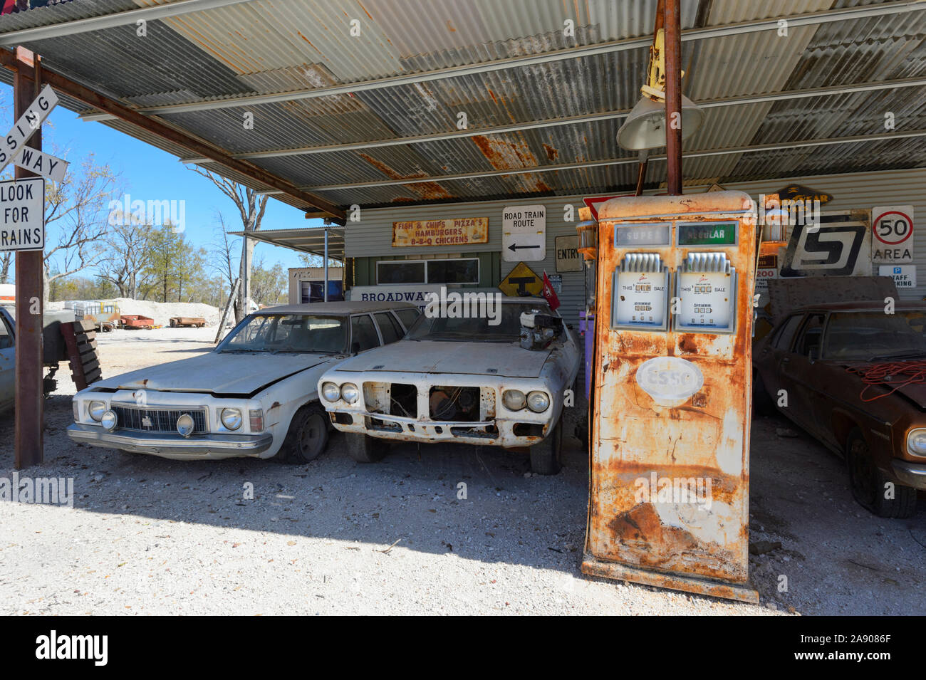 Rusty old fuel pump and vintage cars outside the popular outback pub ...