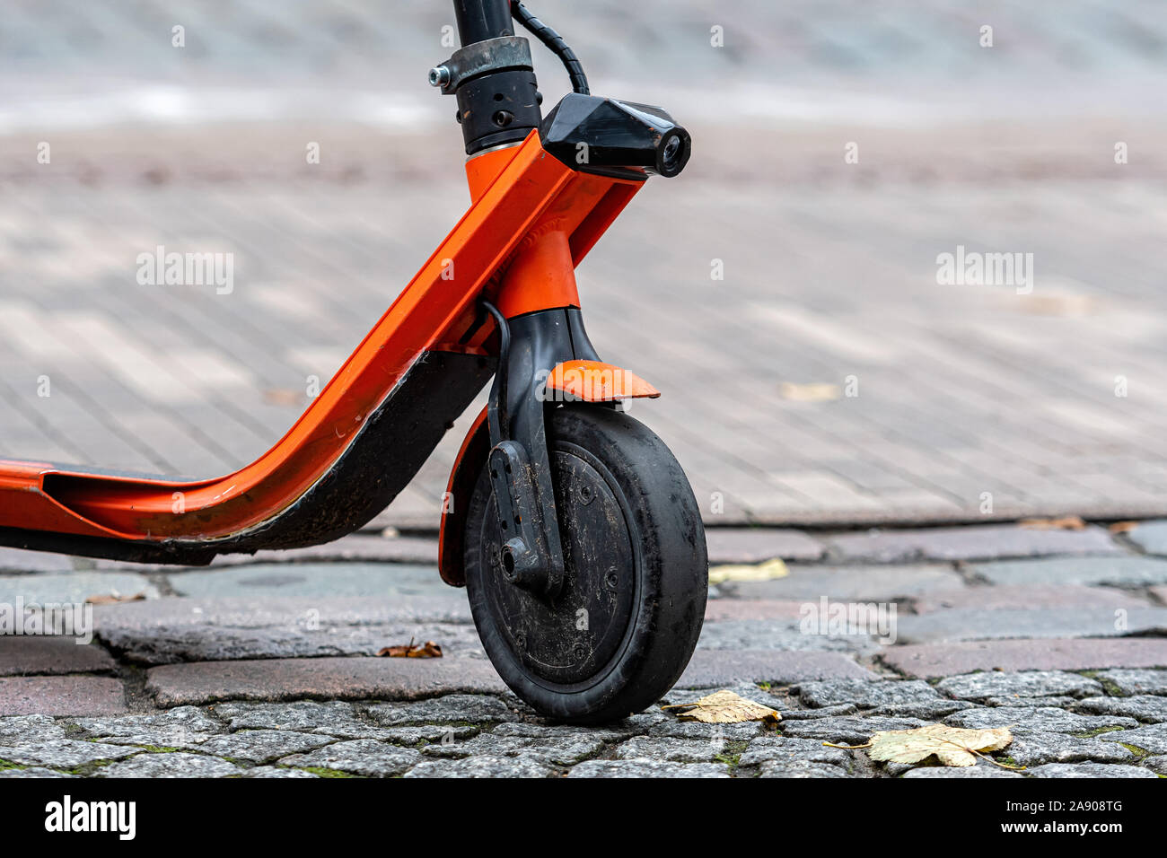 electric scooter front wheel close-up on the sidewalk pavement - image ...