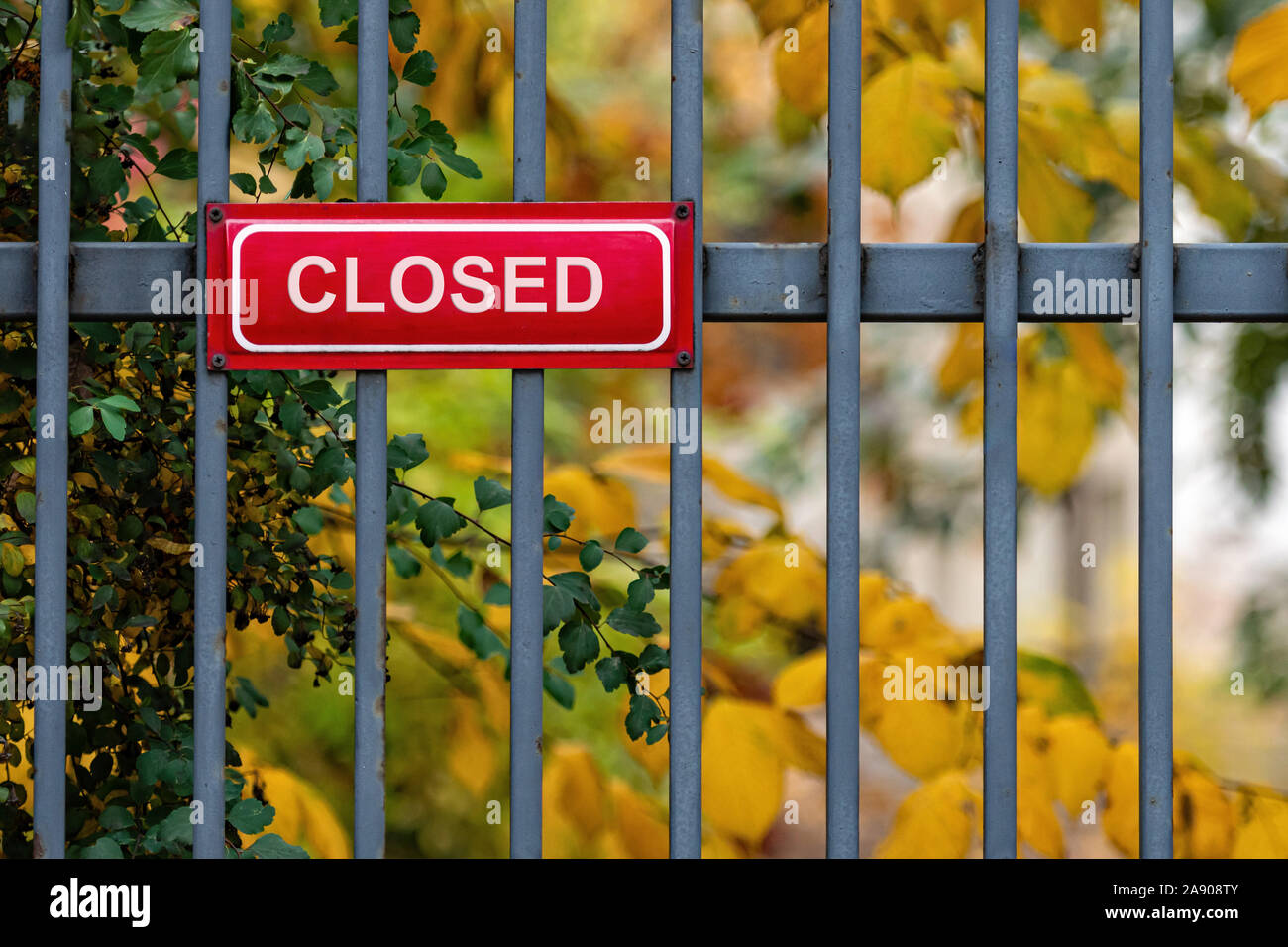 red metal sign with an inscription CLOSED on a decorative metal fence ...