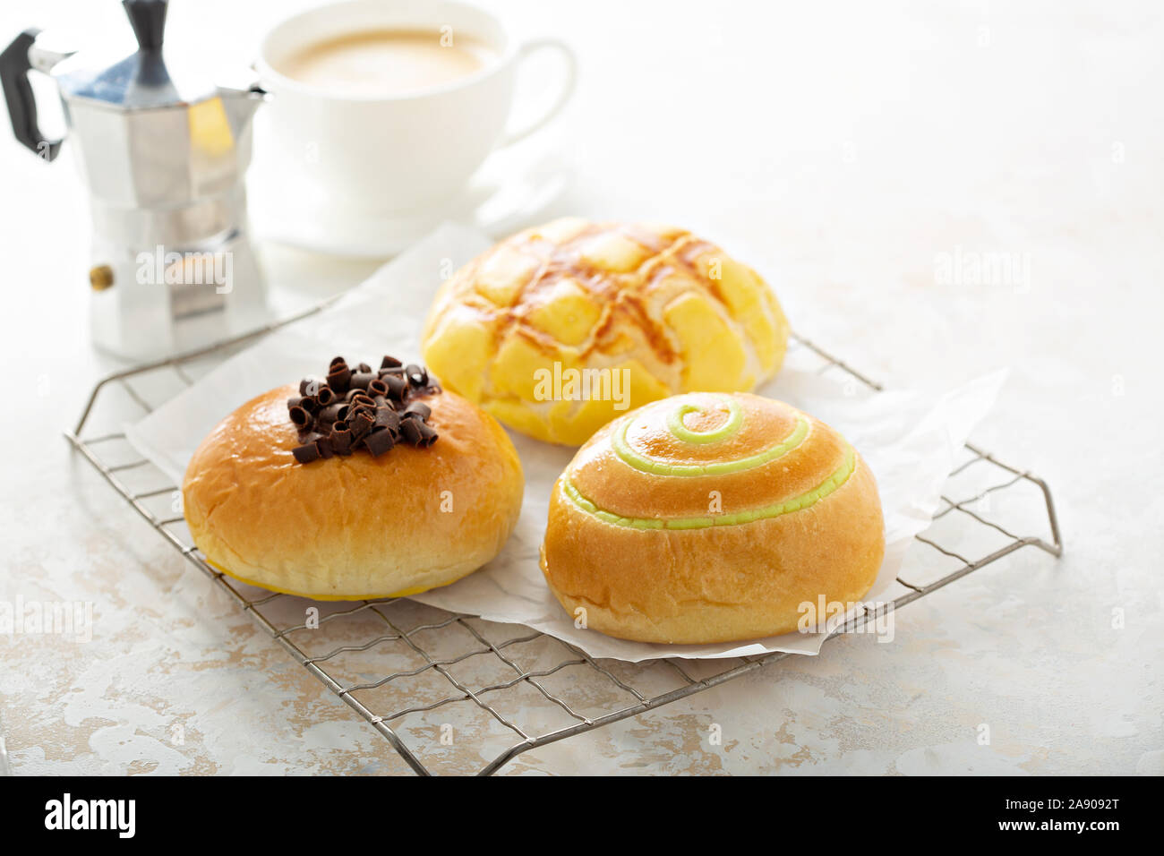 Variety of breakfast buns with a cup of coffee Stock Photo - Alamy