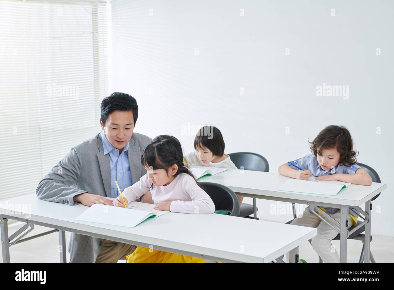 Japanese elementary school kids with teacher Stock Photo - Alamy
