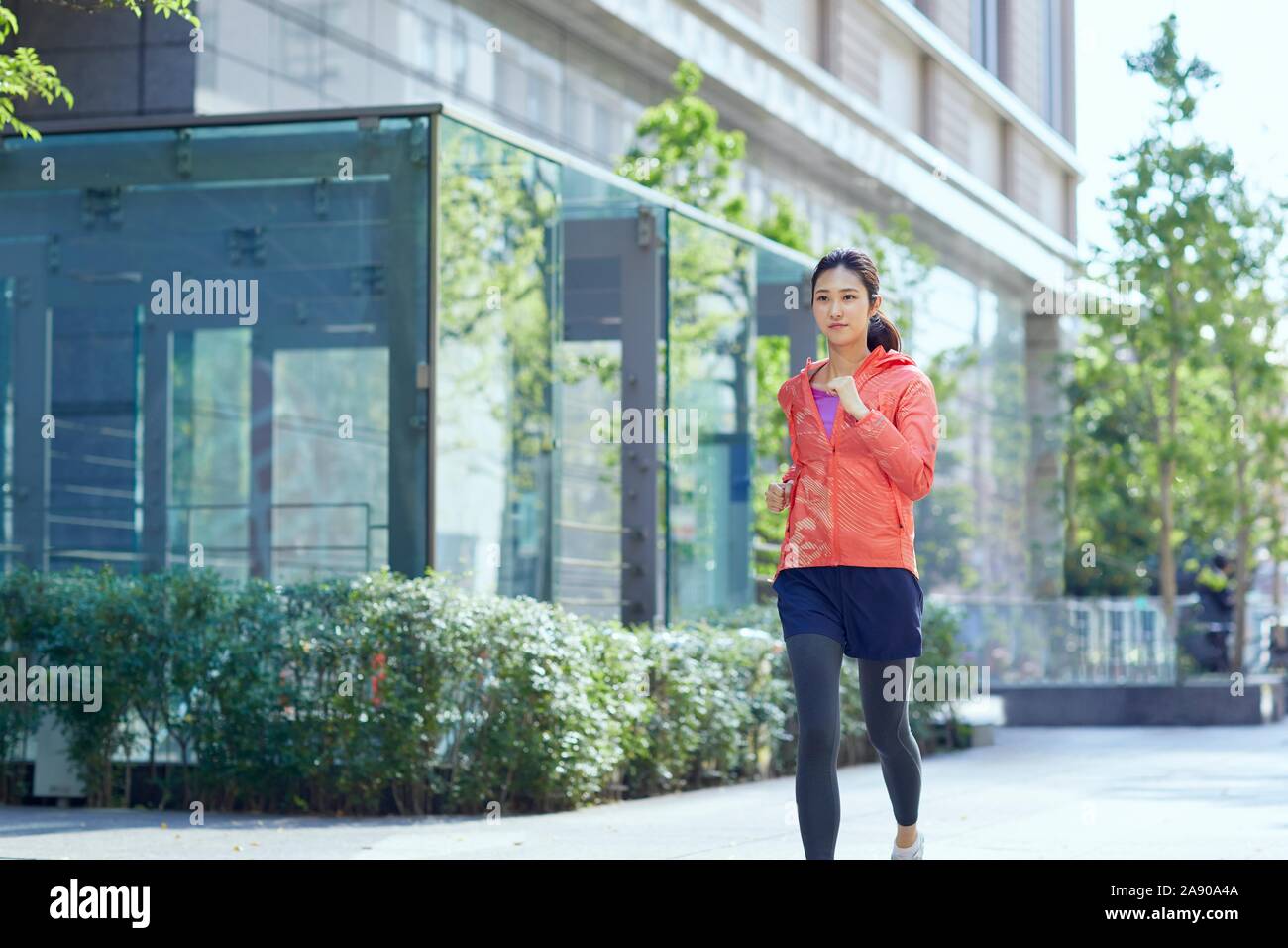 Young Japanese woman running downtown Tokyo Stock Photo - Alamy