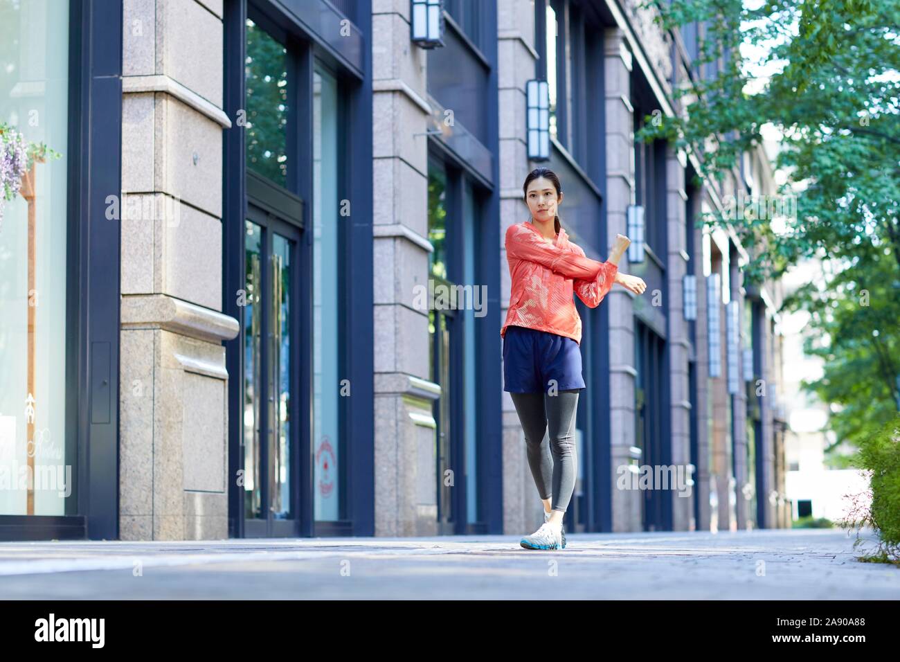 Young Japanese woman running downtown Tokyo Stock Photo - Alamy