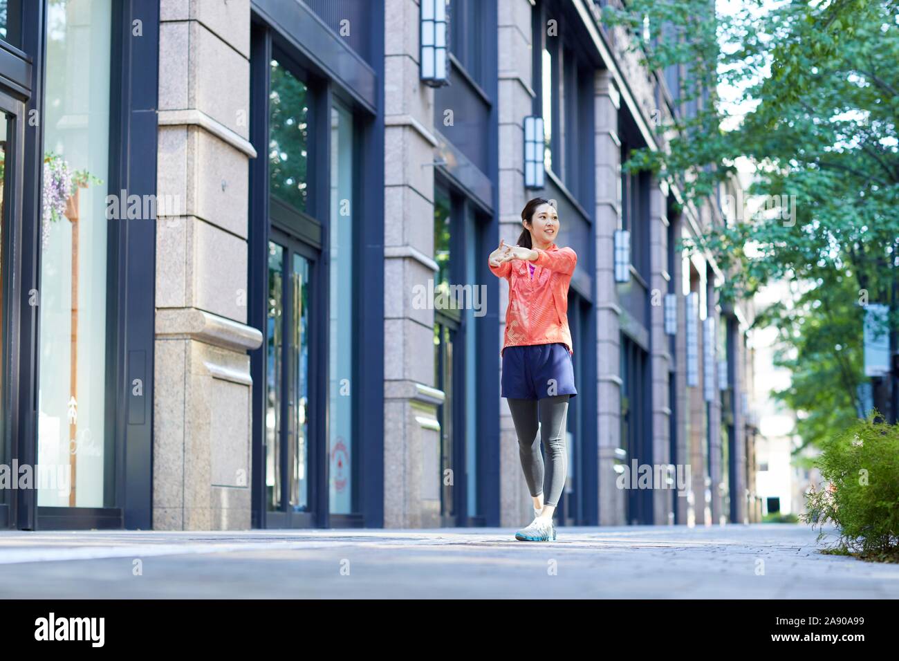 Young Japanese woman running downtown Tokyo Stock Photo - Alamy