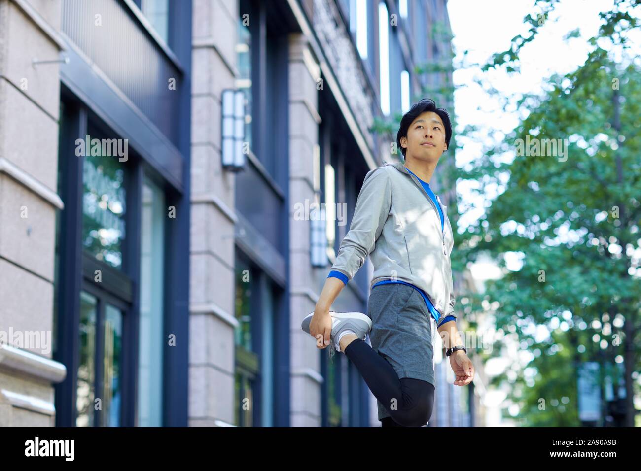 Young Japanese man running downtown Tokyo Stock Photo - Alamy