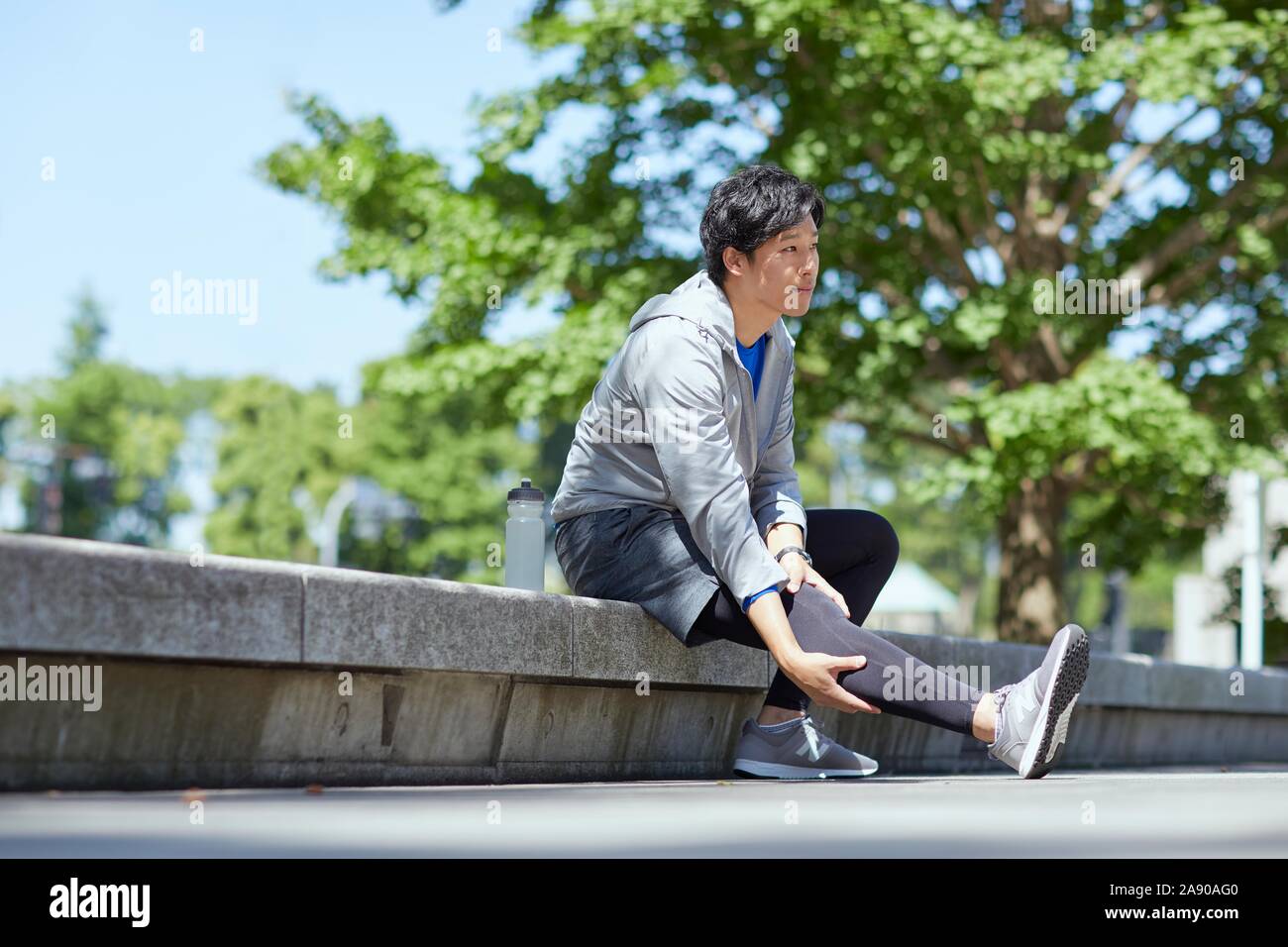 Young Japanese man running downtown Tokyo Stock Photo - Alamy