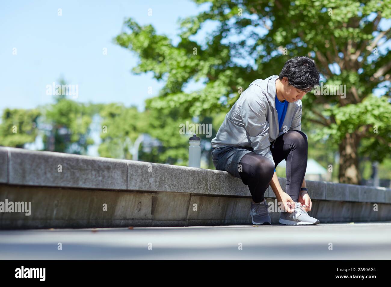 Young Japanese man running downtown Tokyo Stock Photo - Alamy