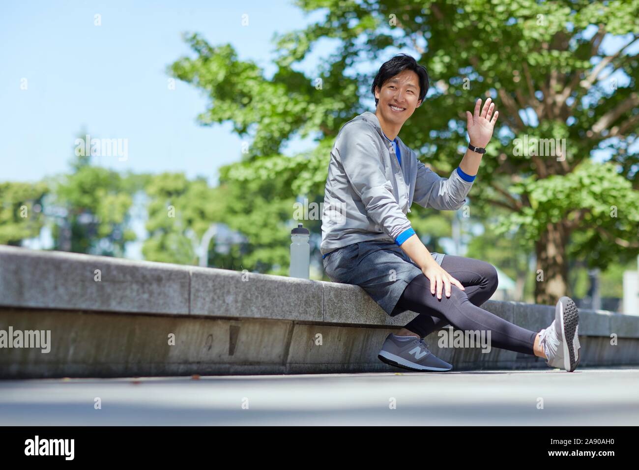 Young Japanese man running downtown Tokyo Stock Photo - Alamy