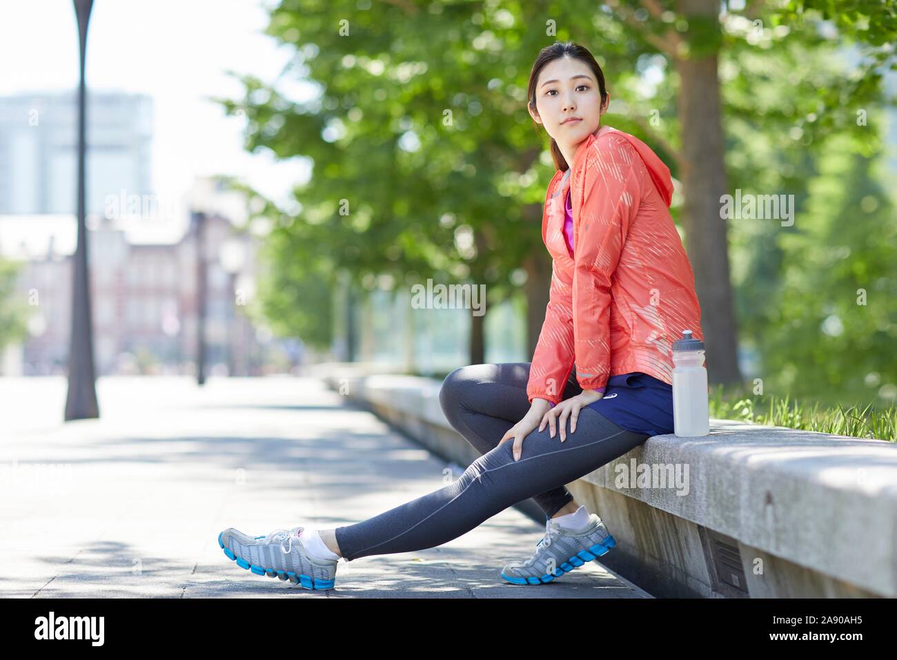 Young Japanese woman running downtown Tokyo Stock Photo - Alamy