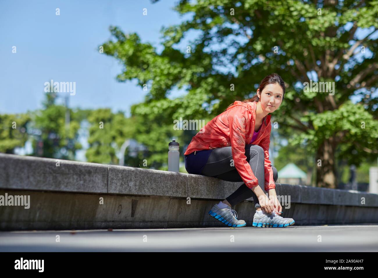 Young Japanese woman running downtown Tokyo Stock Photo - Alamy